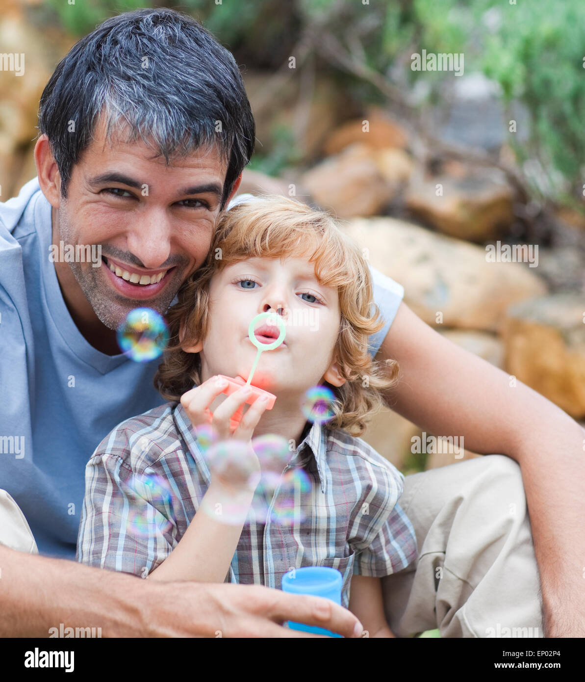 Portrait of a father and son blowing bubbles Stock Photo - Alamy