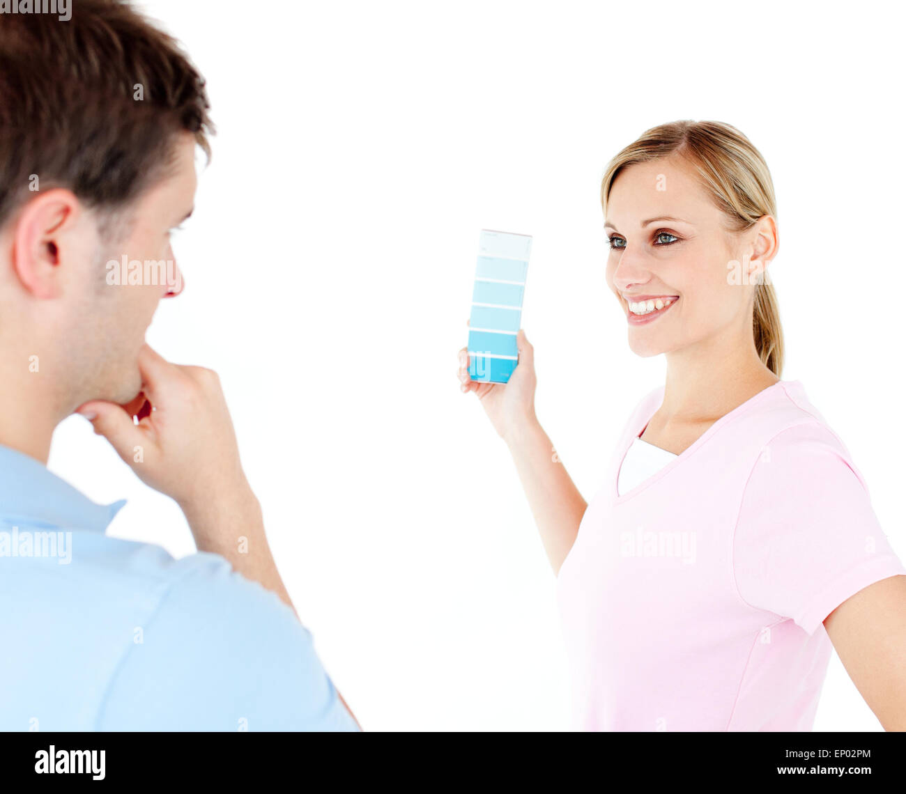 Cheerful woman showing her boyfriend colors for painting a room in ...