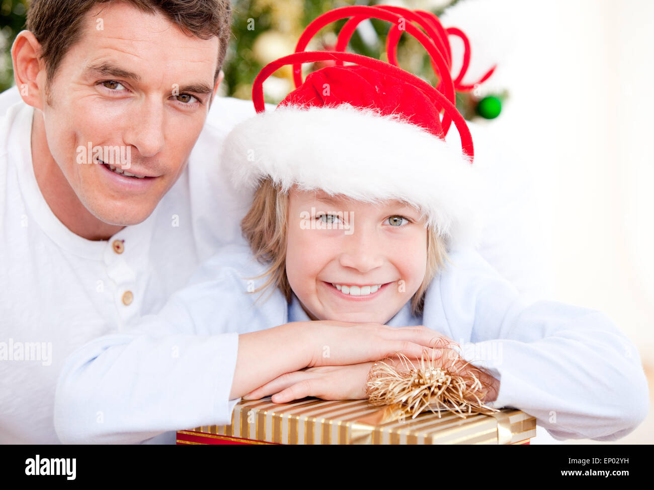Bright father celebrating christmas with his son Stock Photo - Alamy