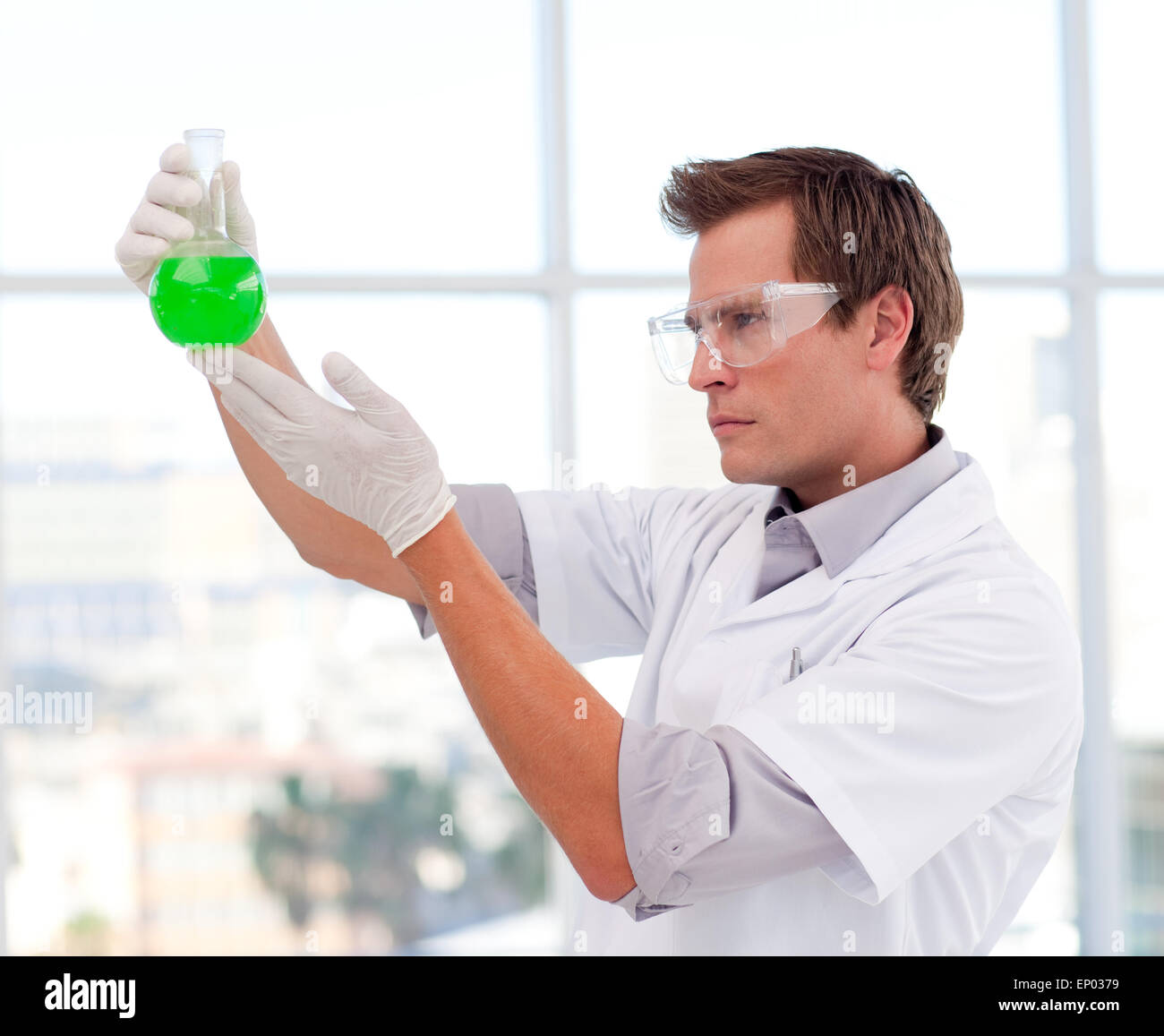 Science student examining a test-tube Stock Photo - Alamy