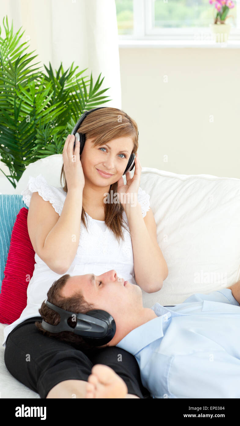 Charming caucasian couple listen to music wearing headphones Stock ...