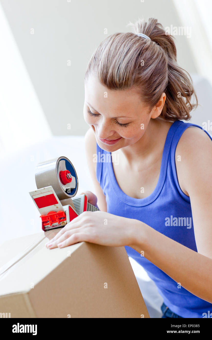Beautiful woman packing boxes in the living-room Stock Photo - Alamy