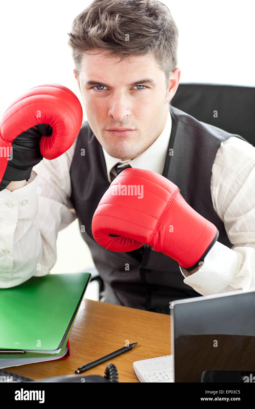 Angry businessman wearing boxing gloves in the office Stock Photo - Alamy