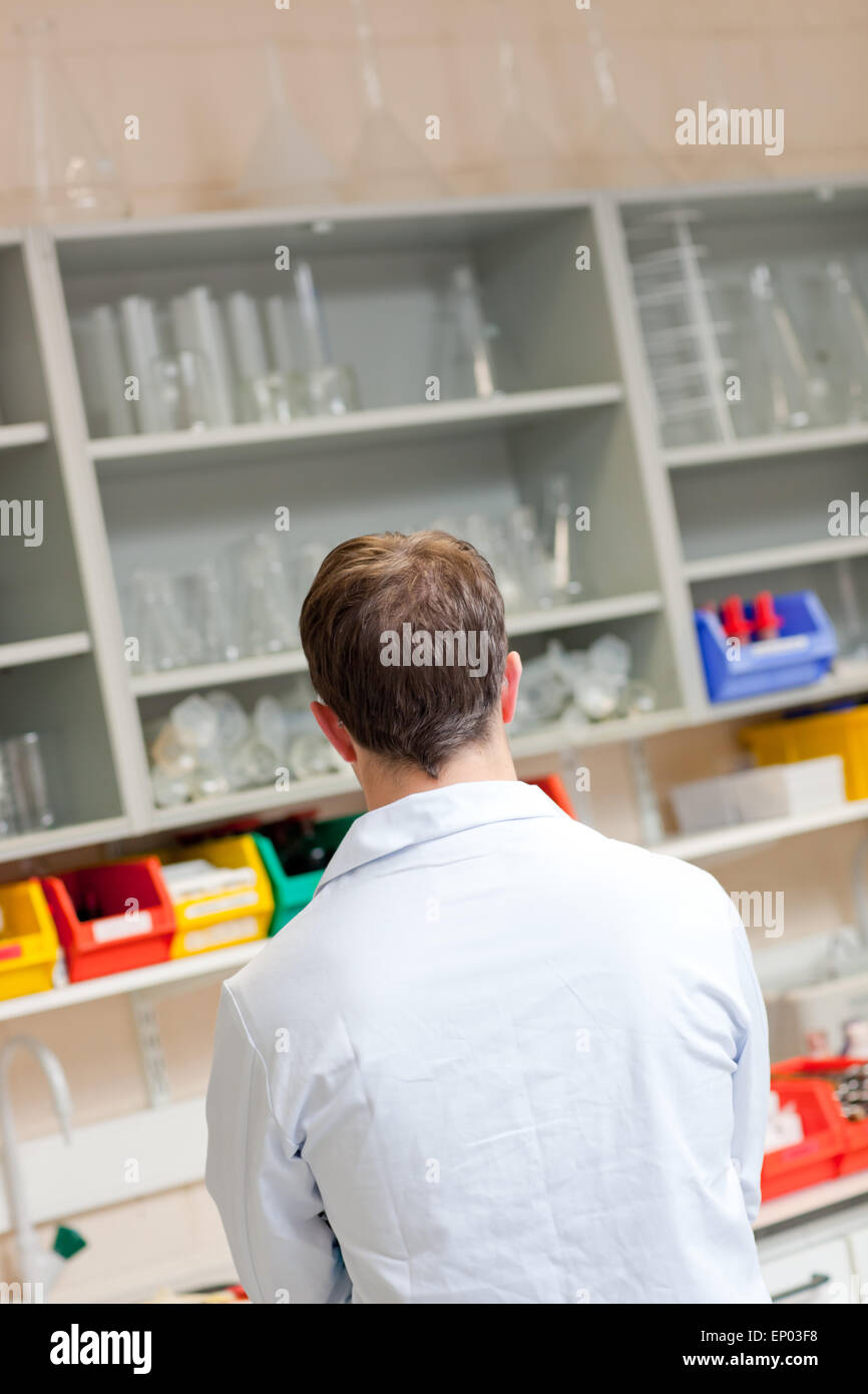 Concentrated male scientist thinking Stock Photo - Alamy