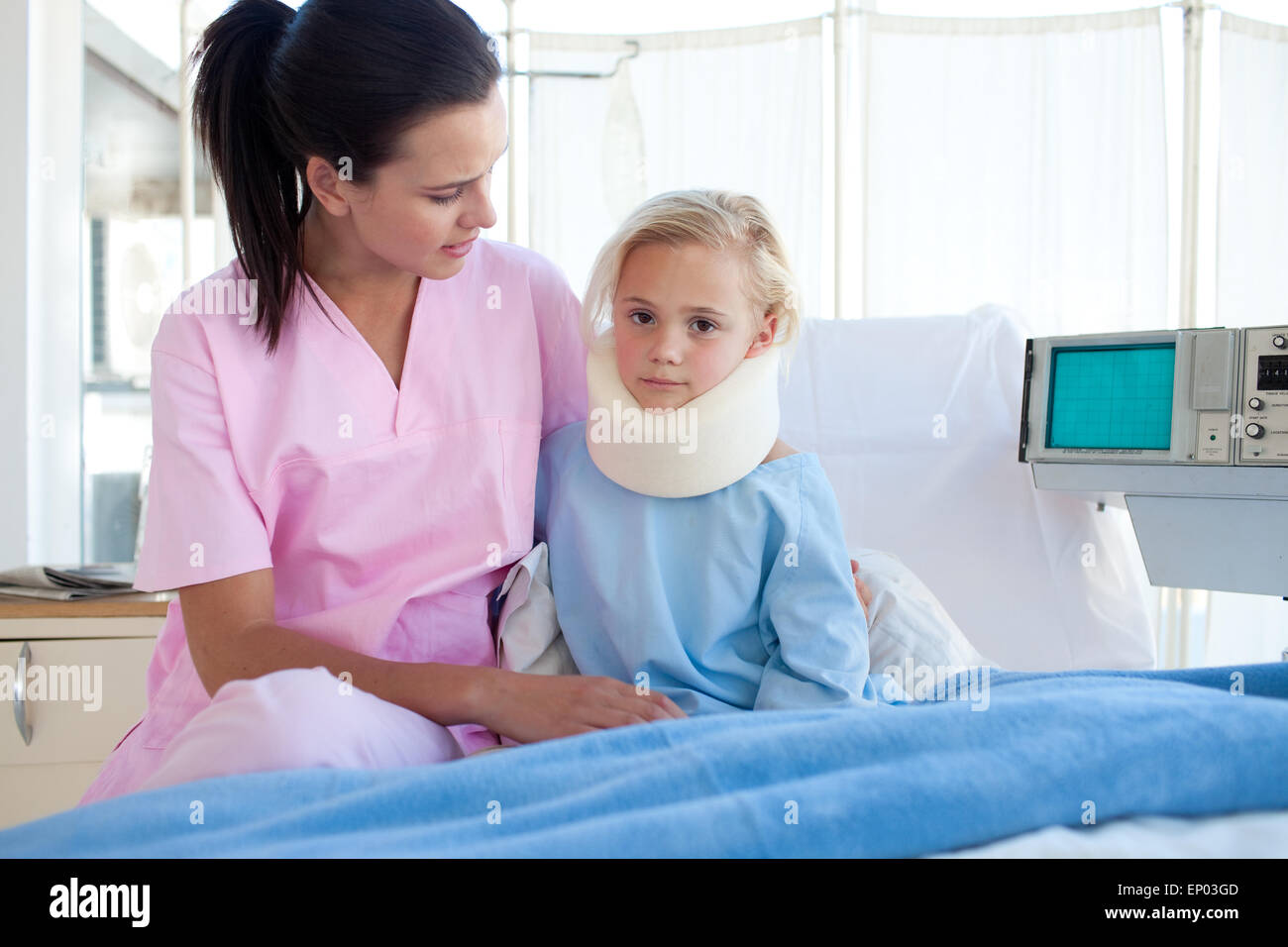 A nurse looking after a petient wih a neck brace Stock Photo - Alamy