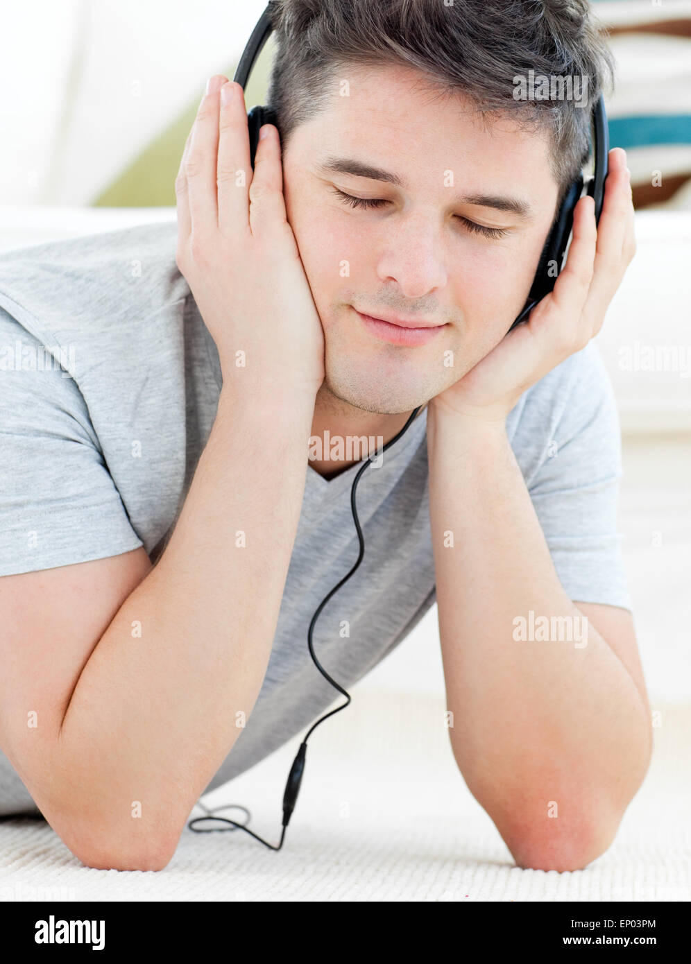 Positive young man listen to music with closed eyes Stock Photo - Alamy