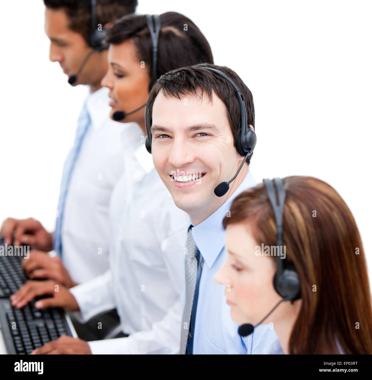 Portrait of smiling business team with headset on against white ...