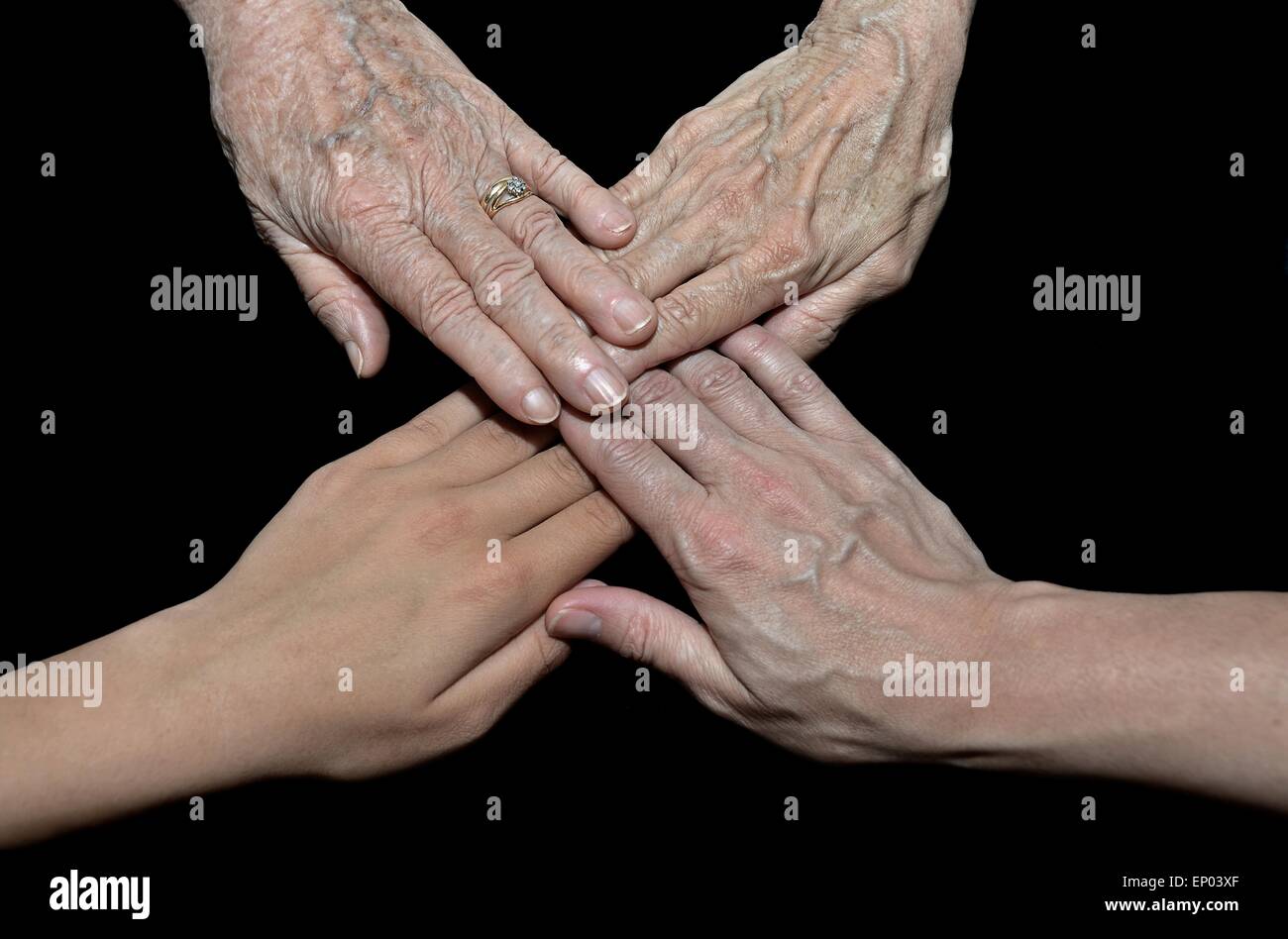Hands representing four family generations isolated on black Stock ...
