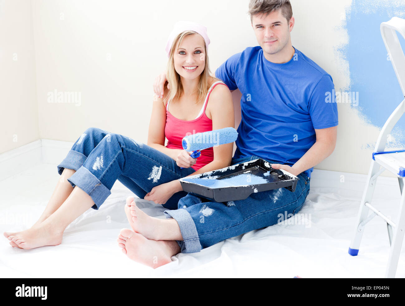 Affectionate couple painting a room together Stock Photo - Alamy