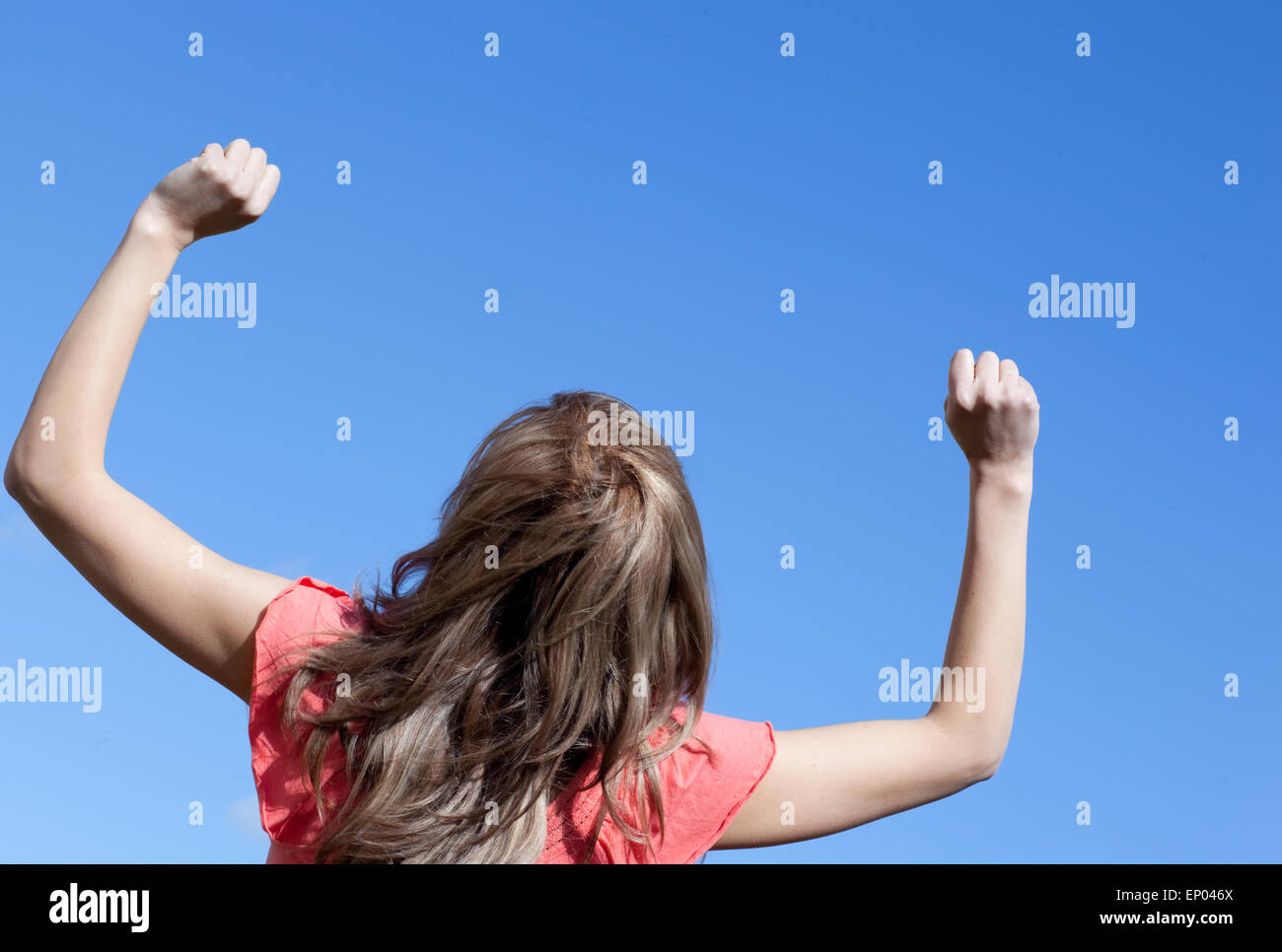 Smiling woman punching the air outdoor Stock Photo - Alamy