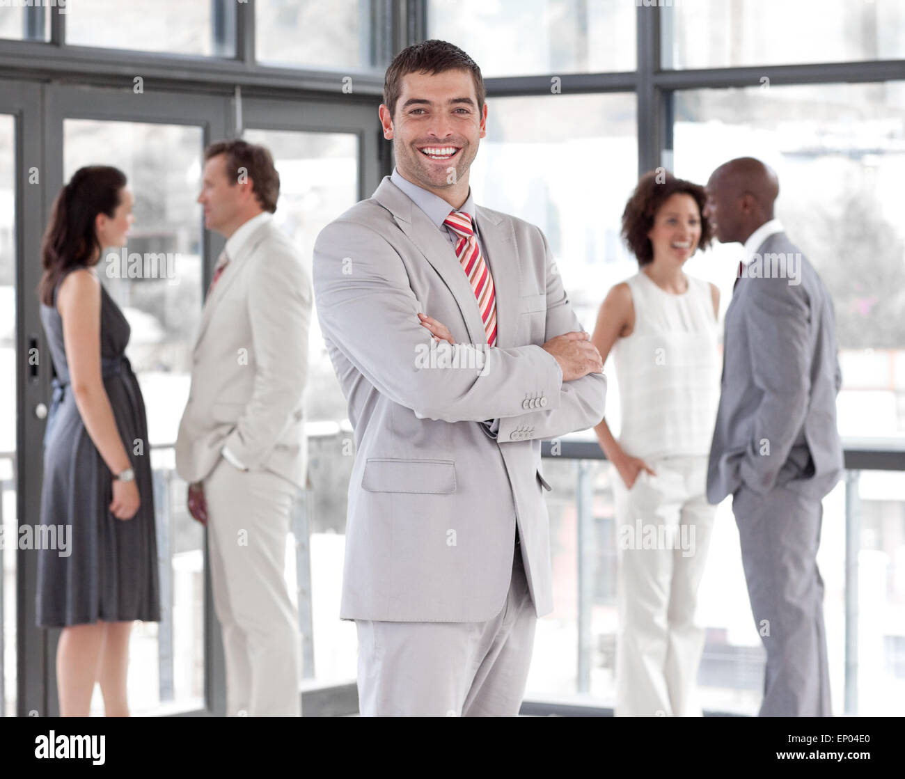 portrait of a smiling manager leading his team Stock Photo - Alamy