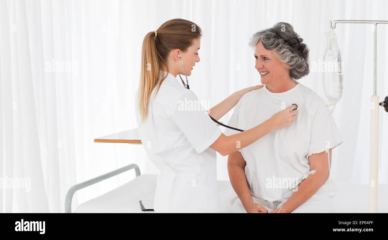Nurse taking the heartbeat of her patient Stock Photo - Alamy