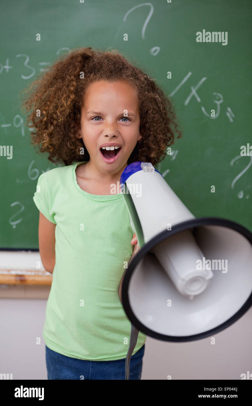 Portrait of a young schoolgirl screaming through a megaphone Stock ...