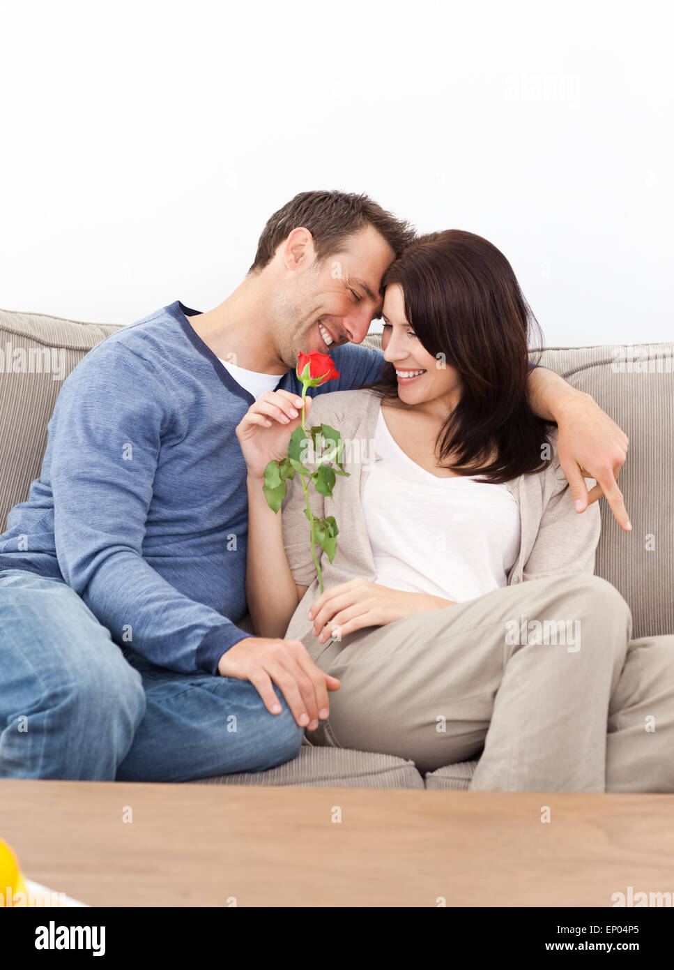 Enamored couple sitting together on the sofa Stock Photo - Alamy