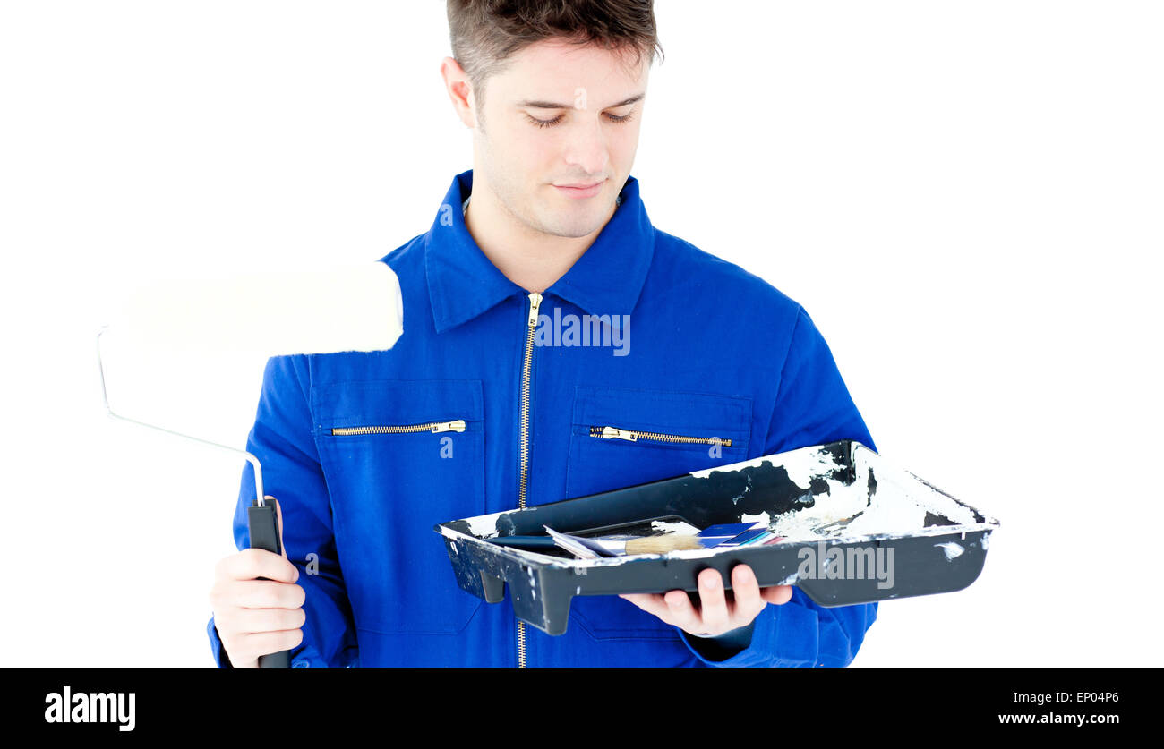 Young male worker holding colors and brush against white background ...