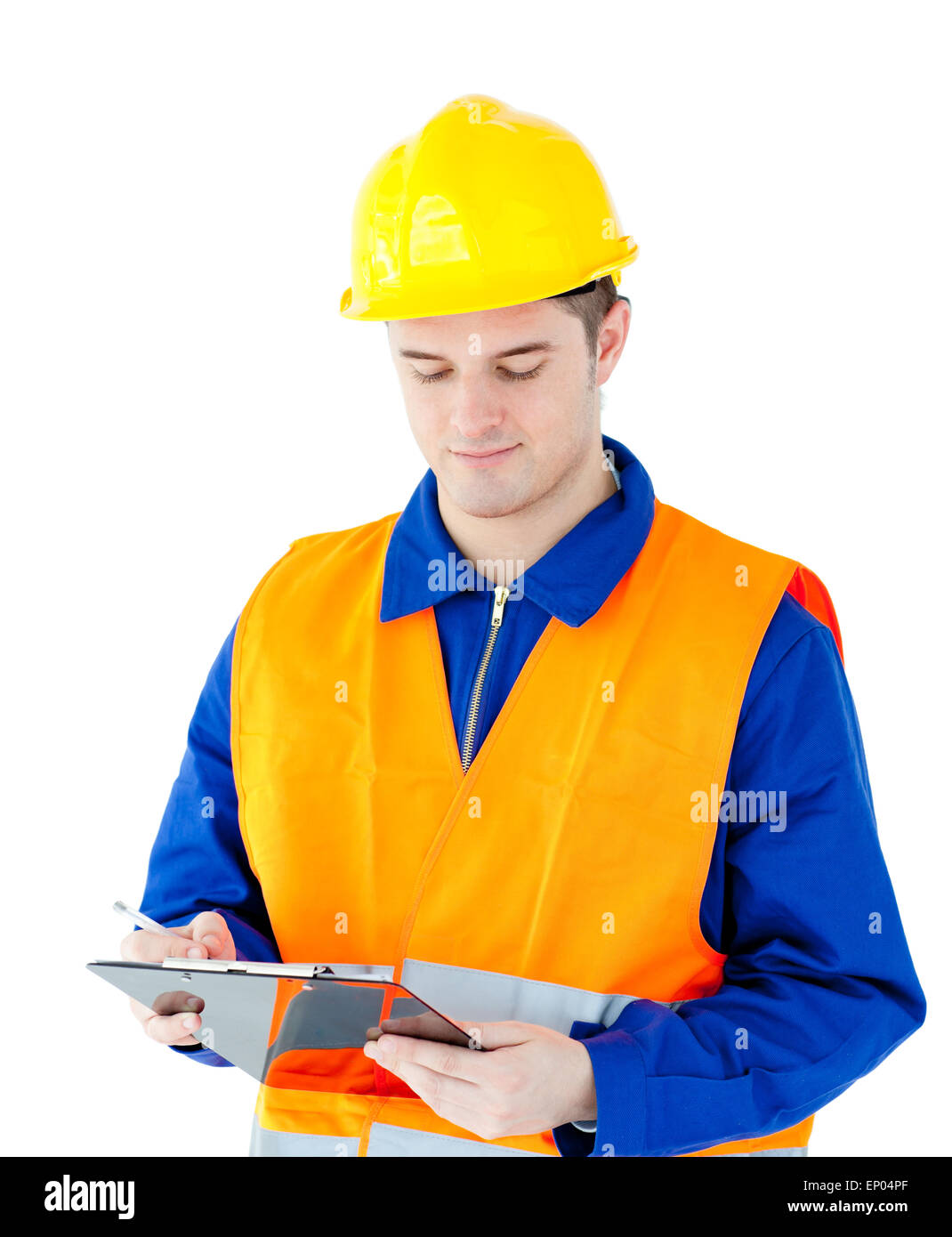 Charming young worker writing on a clipboard against white background ...