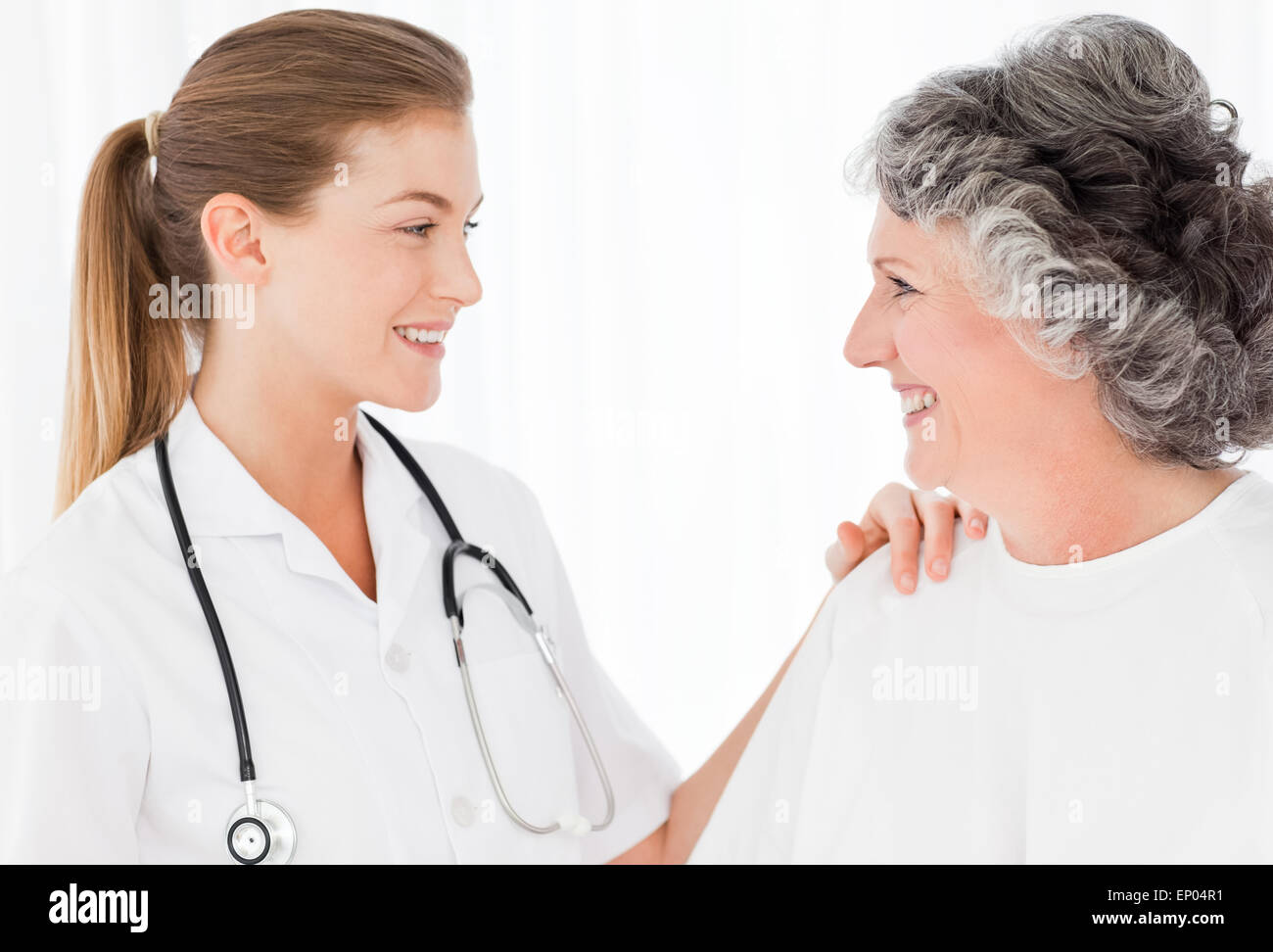 Patient with her nurse smiling Stock Photo - Alamy