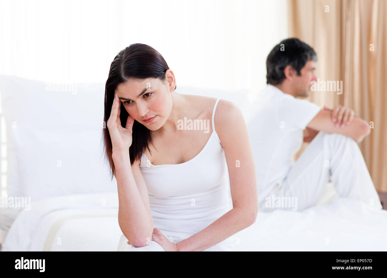 Angry couple having an argument sitting on bed Stock Photo - Alamy