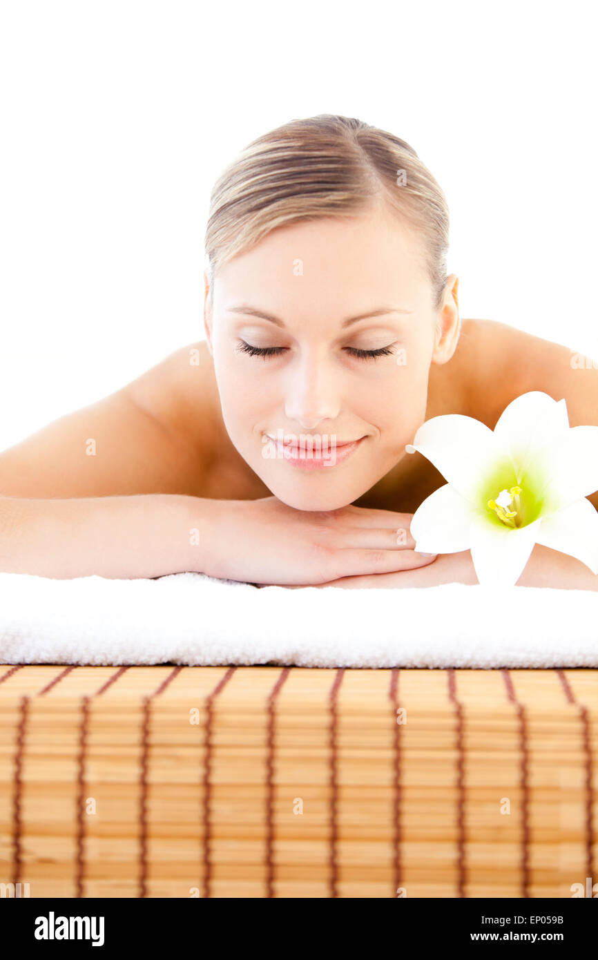 Close Up Of A Delighted Woman Lying On A Massage Table With A Flower In