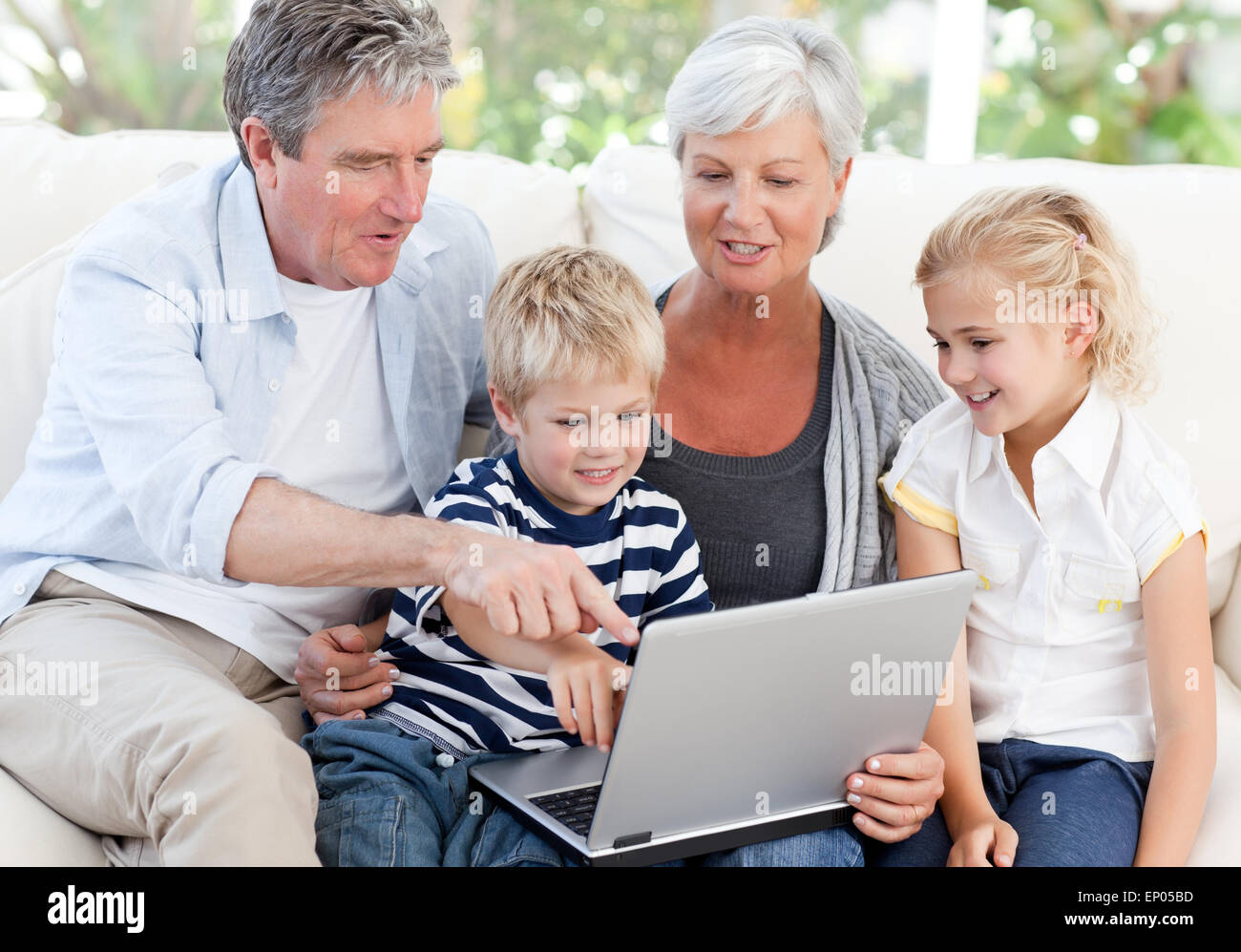 Adorable family looking at their laptop Stock Photo - Alamy