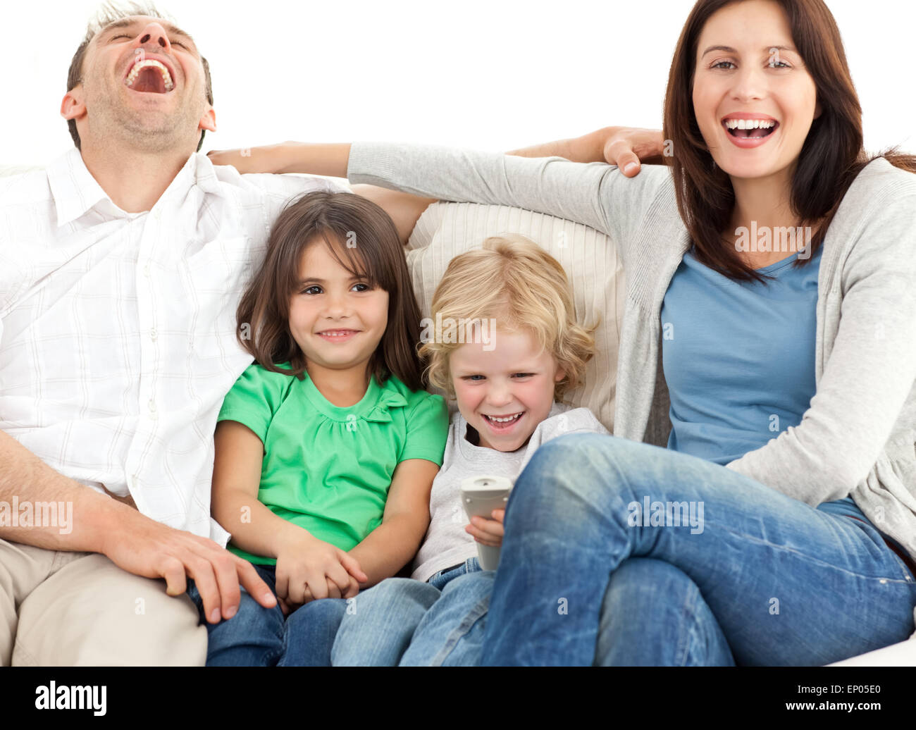 Family laughing while watching television together Stock Photo - Alamy