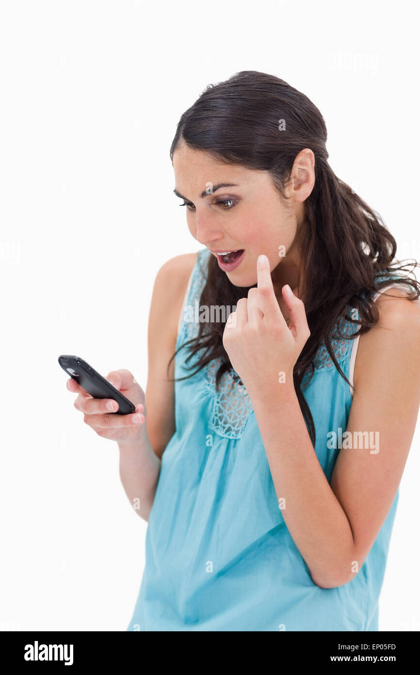 Portrait of an amazed woman reading a text message Stock Photo - Alamy