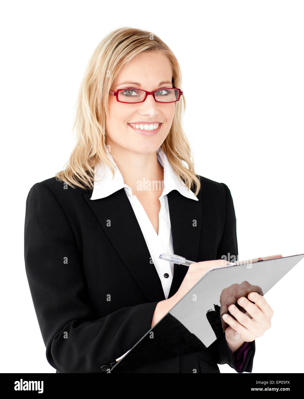 Charming businesswoman writing on a clipboard against white background ...