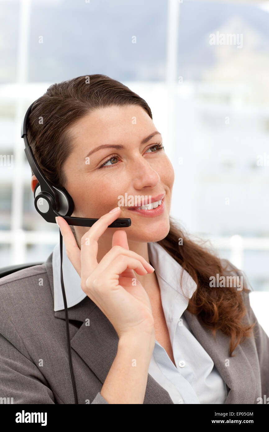 Pensive businesswoman talking on the phones using headphones Stock ...
