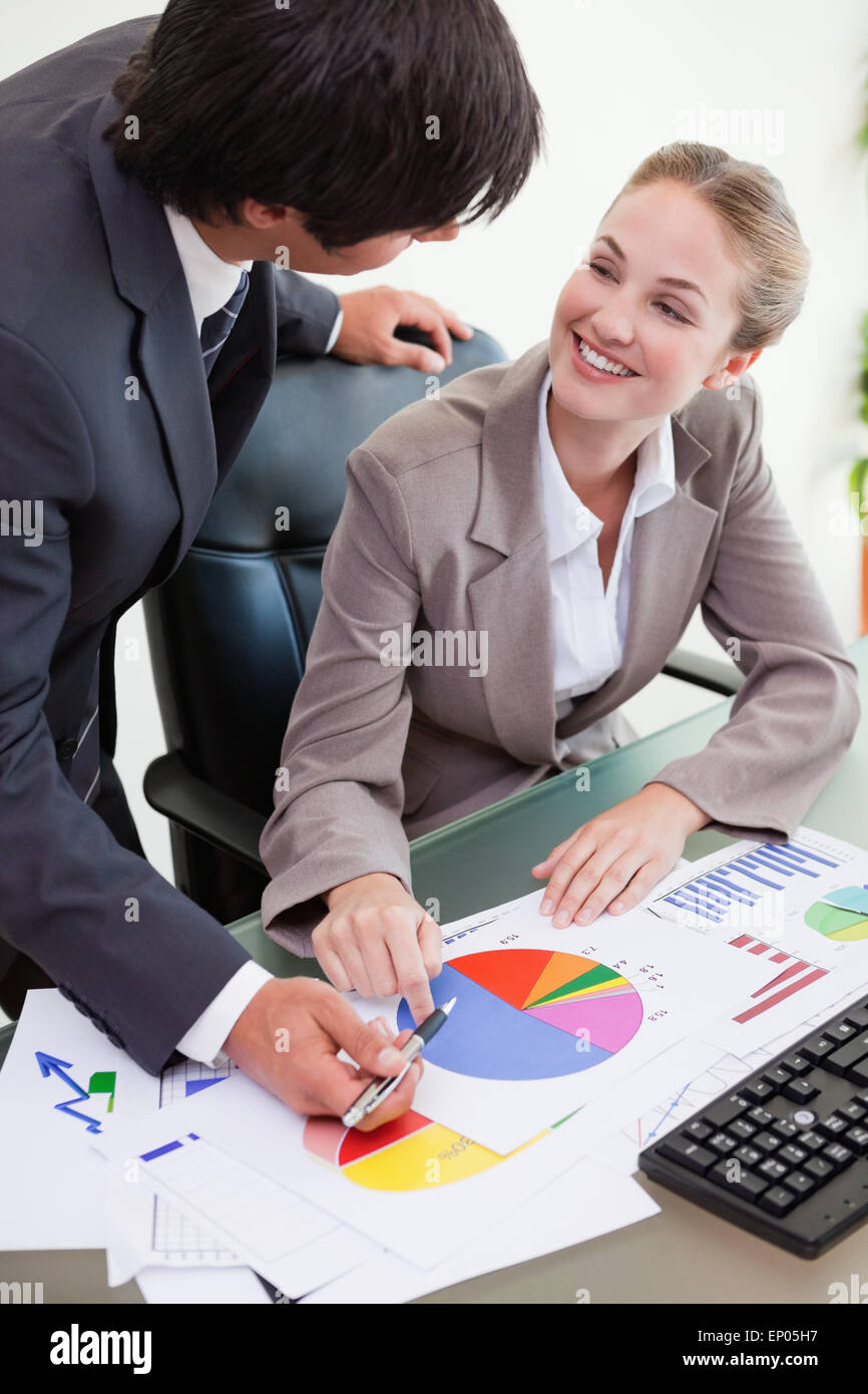 Portrait of a young business team studying statistics Stock Photo - Alamy