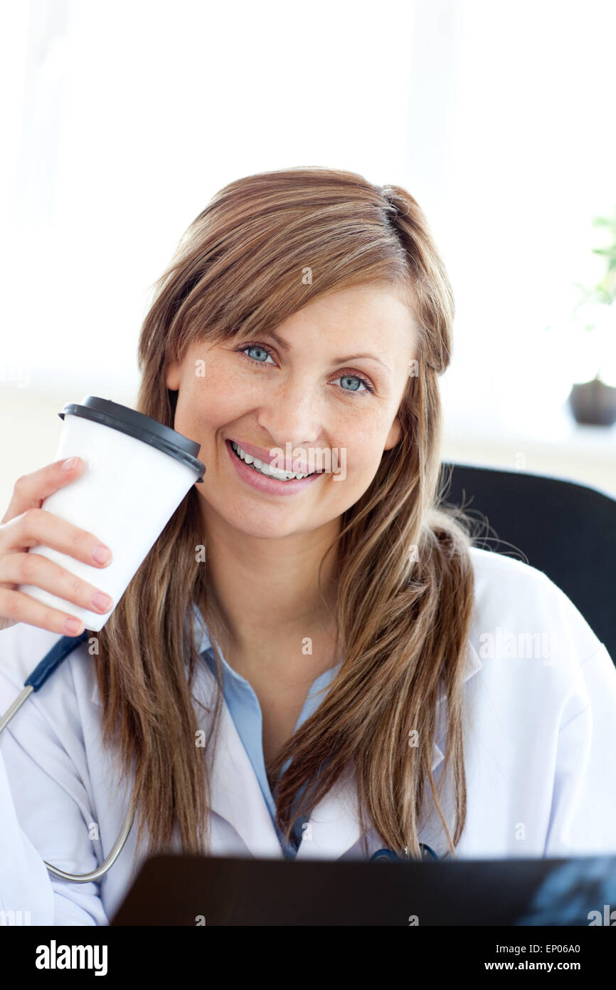 Happy female doctor drinking Stock Photo - Alamy