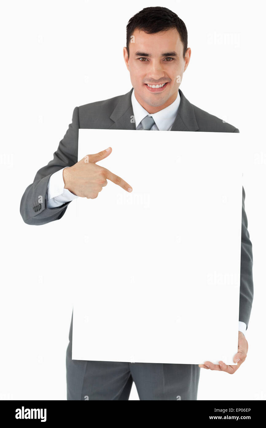 Smiling businessman pointing at the sign in his hands Stock Photo - Alamy