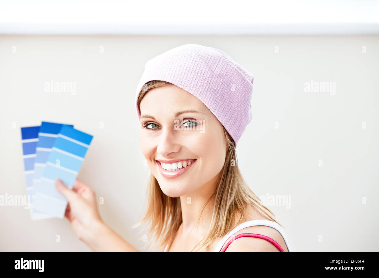 Joyful young woman choosing color for painting a room Stock Photo - Alamy