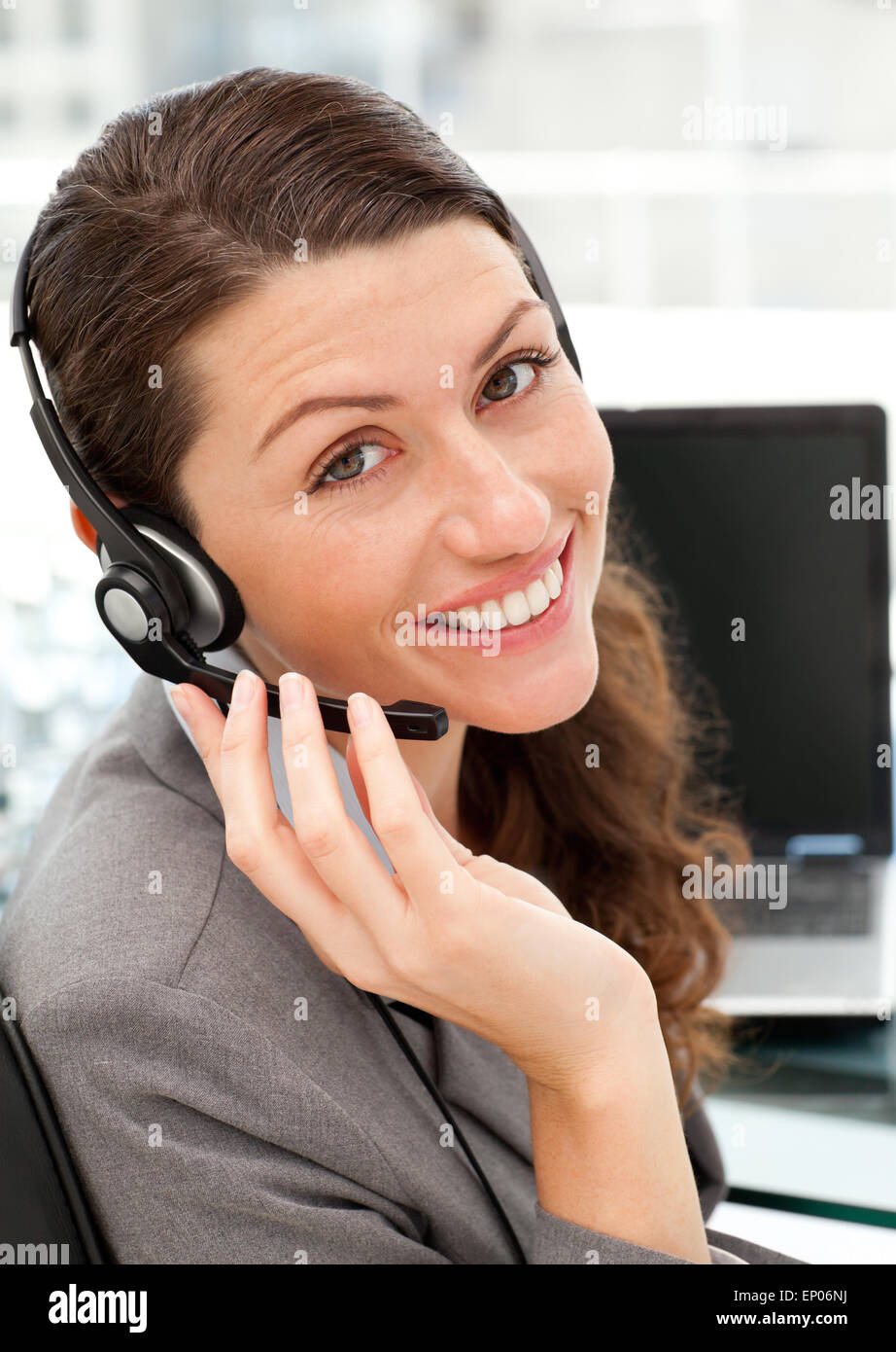 Pretty female representative on the phone with earpiece on Stock Photo ...