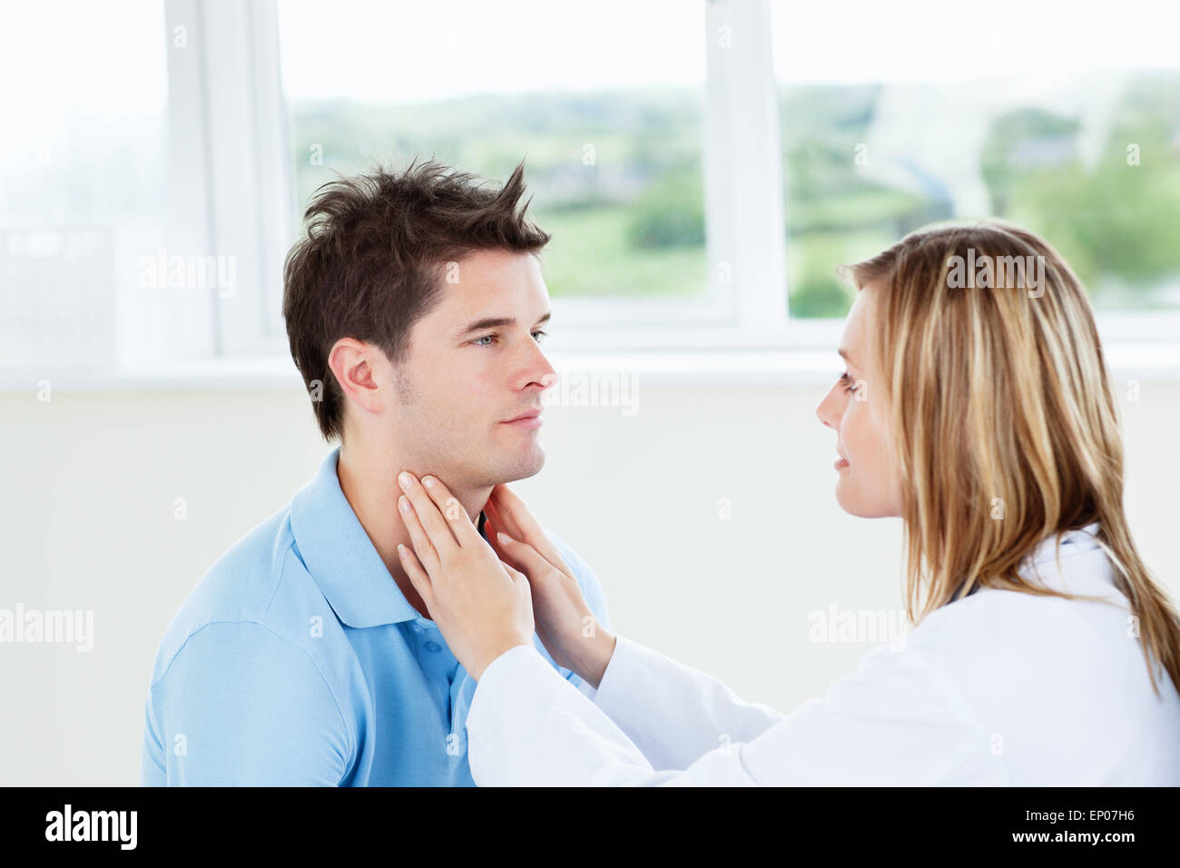 Female doctor examinating her male patient Stock Photo - Alamy