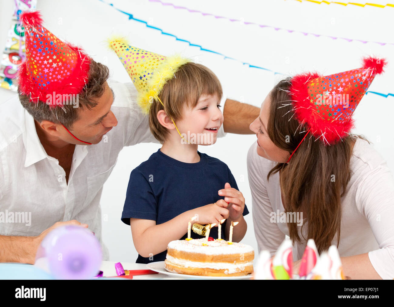 Attentive parents celebrating their son's birthday Stock Photo - Alamy