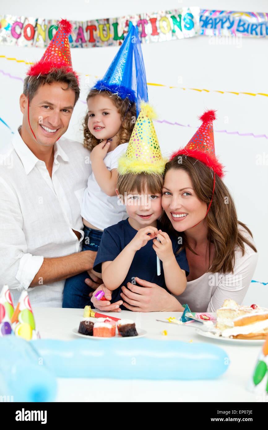 Portrait of cute children with their parents during a birthday party ...
