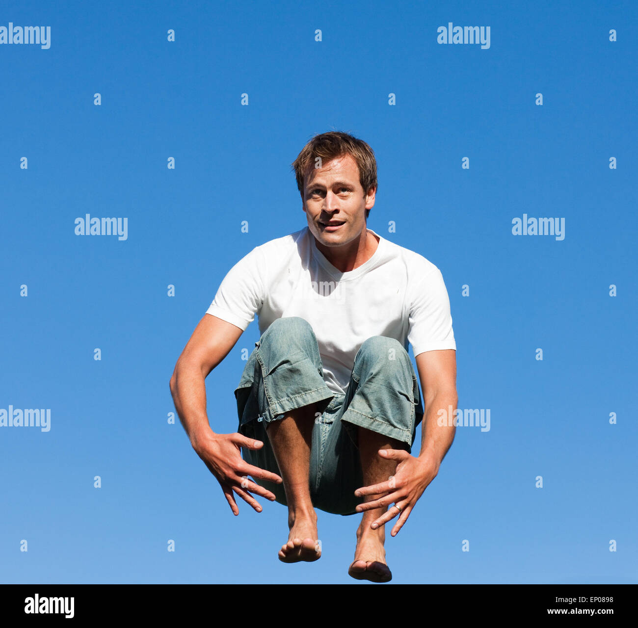 Back man jumping air beach hi-res stock photography and images - Alamy