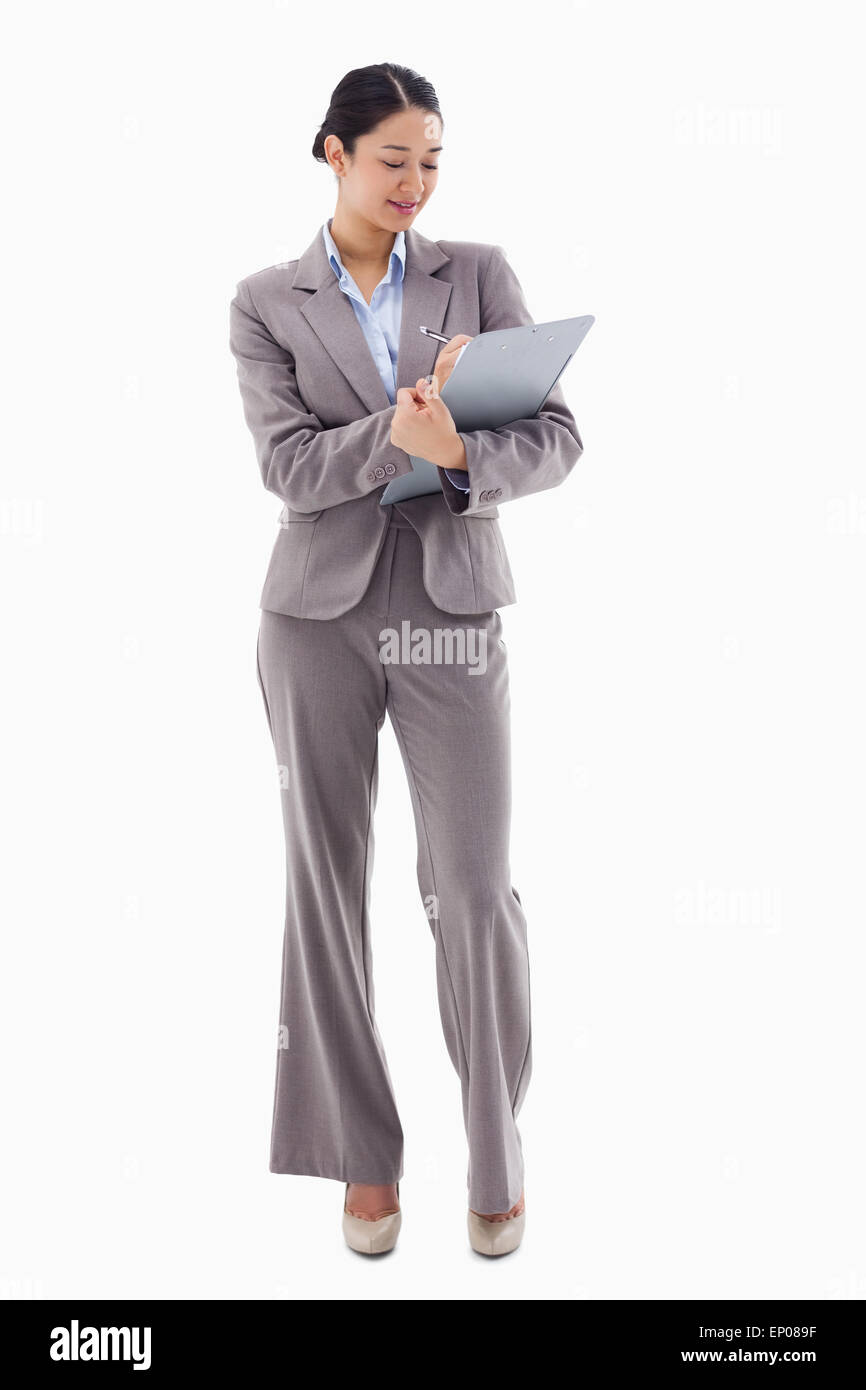 Portrait of a smiling businesswoman taking notes Stock Photo - Alamy