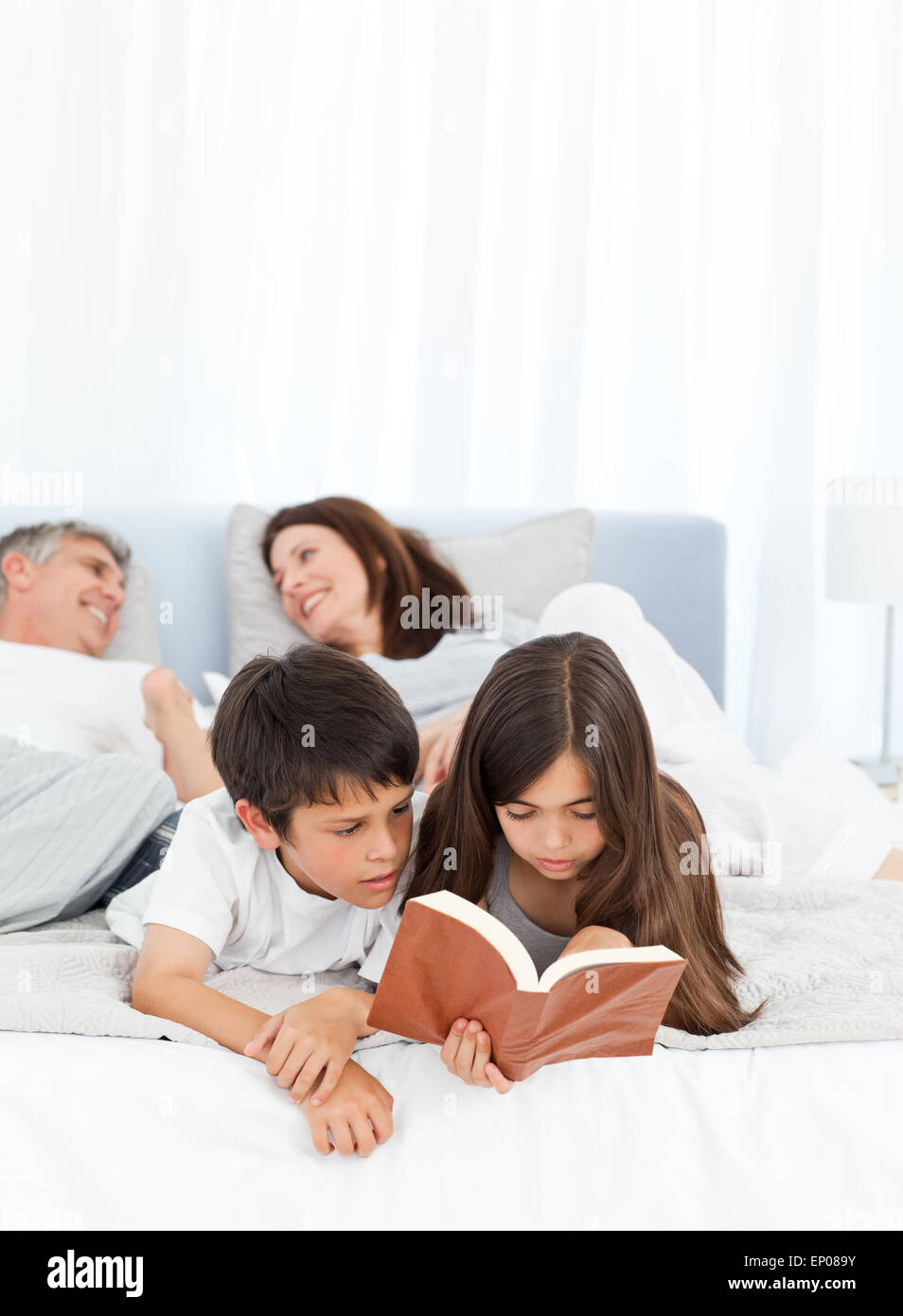Parents talking while their childrens are reading Stock Photo - Alamy