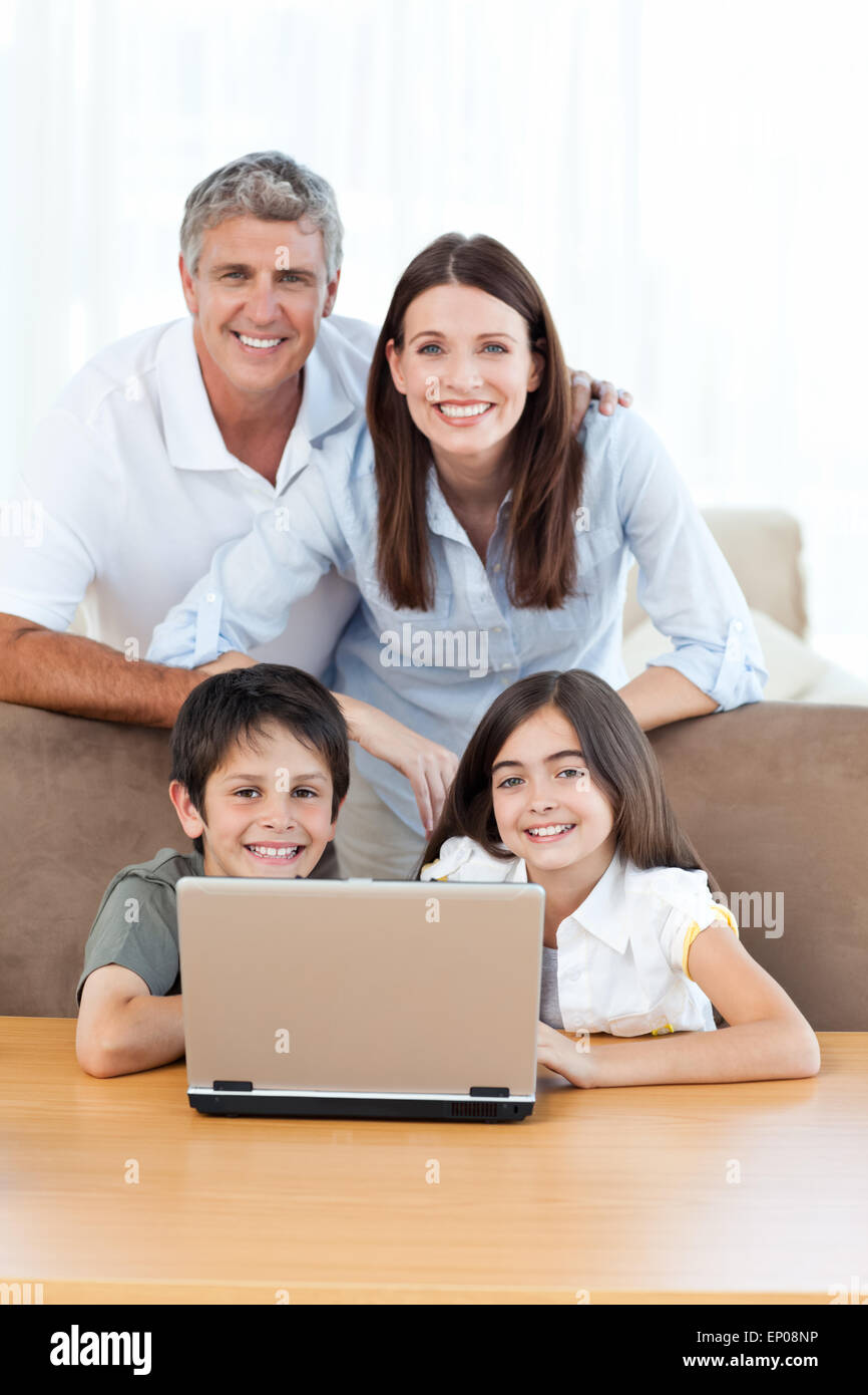 Joyful family looking at the camera Stock Photo - Alamy