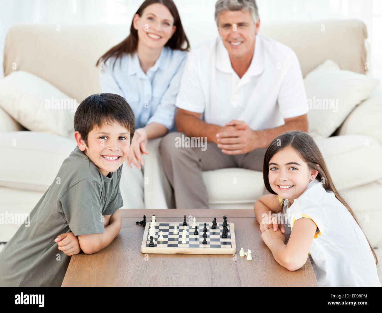 Portrait of a little family in their living room Stock Photo - Alamy