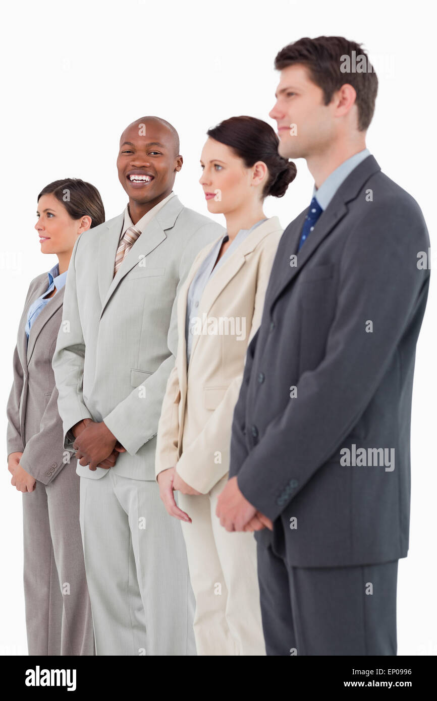 Smiling businessman standing between his colleagues Stock Photo - Alamy