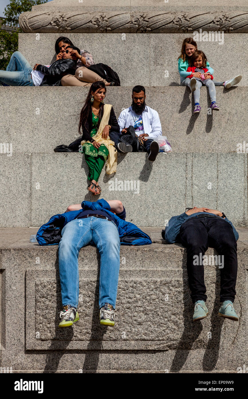People Sitting On The Base Of Nelson's Column In Trafalgar Square ...