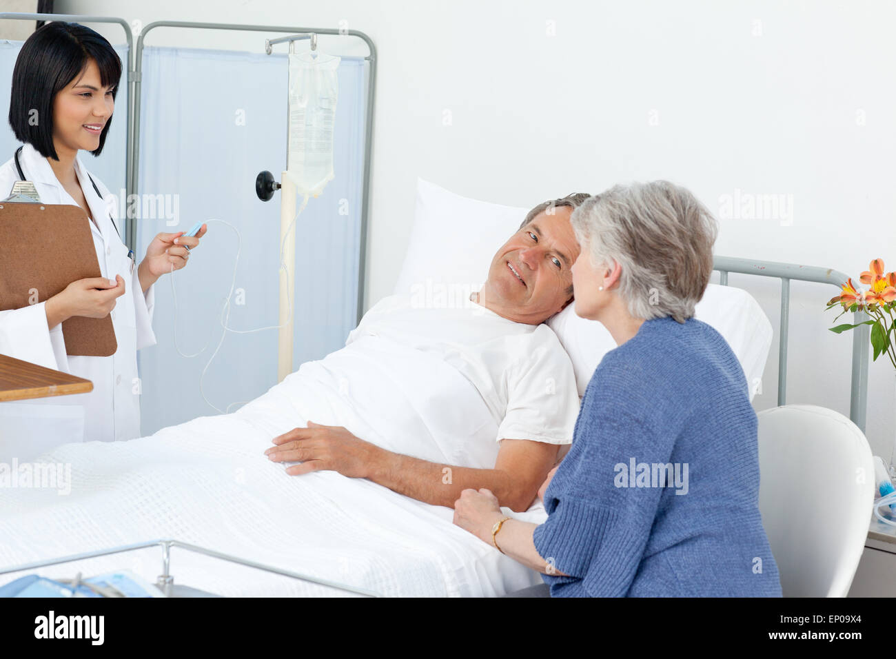 Nurse with a couple in a hospital Stock Photo - Alamy
