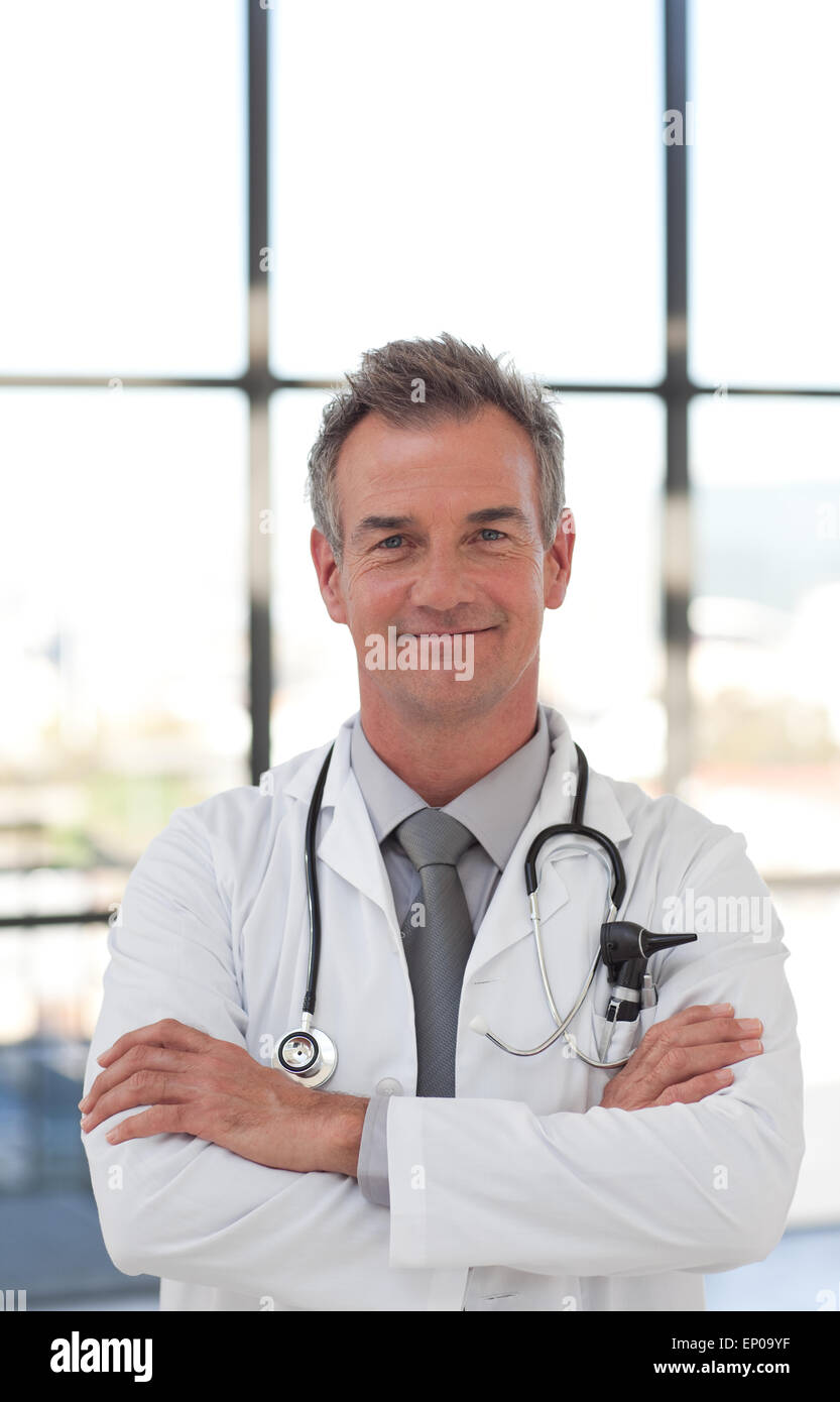 Smiling doctor with folded arms Stock Photo - Alamy