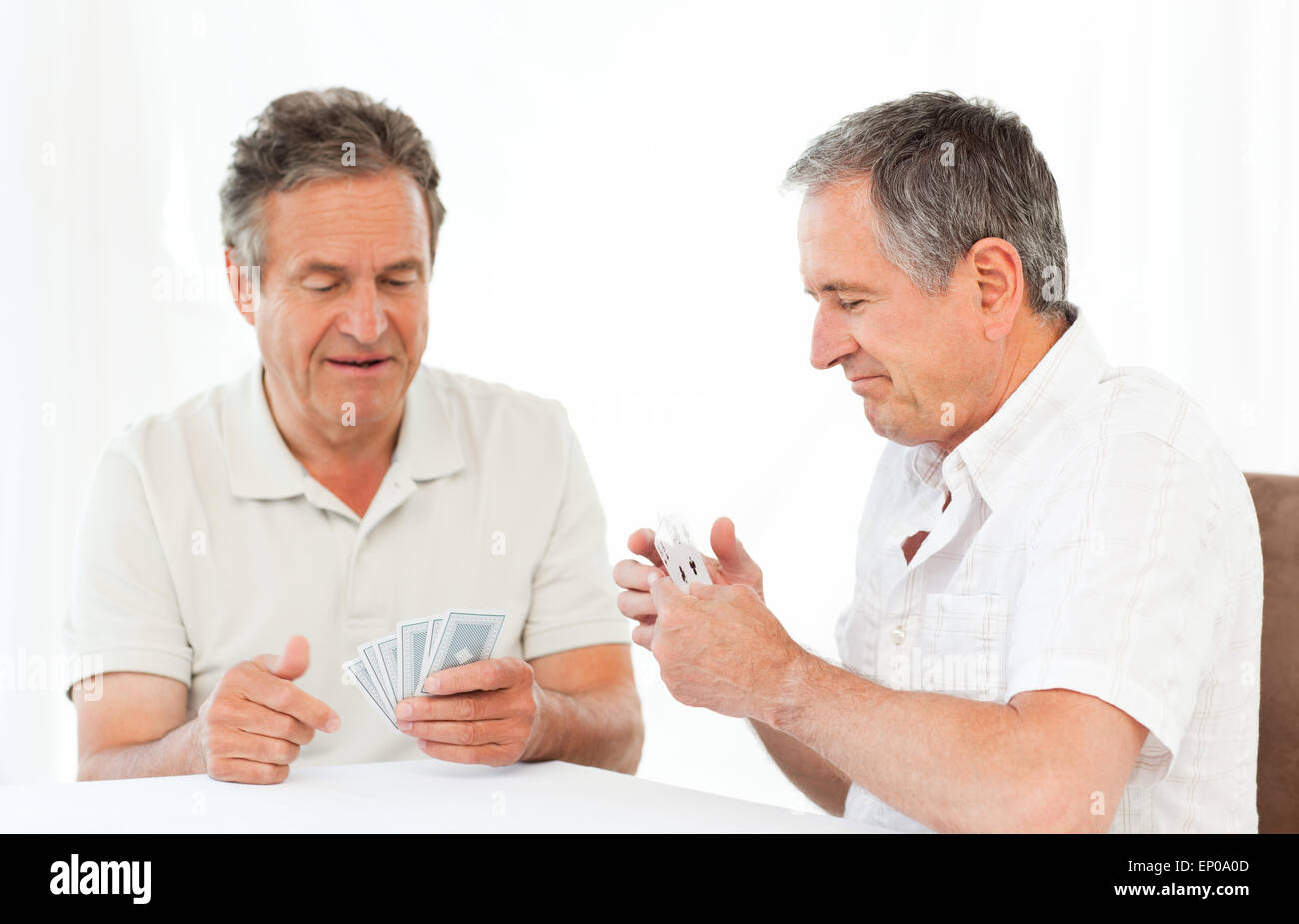 Men playing cards on the table Stock Photo - Alamy