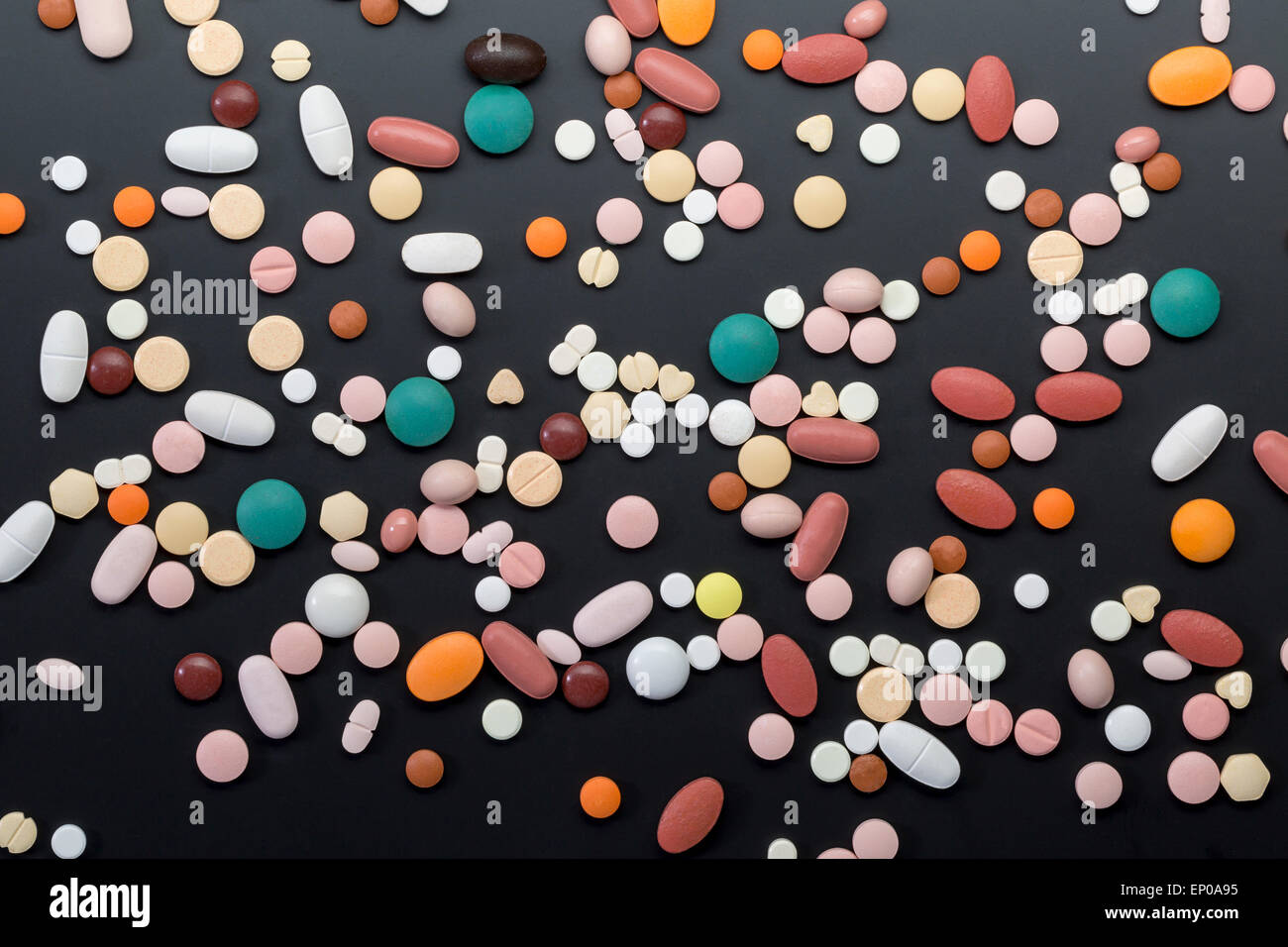 Many different colorful pills on black background Stock Photo - Alamy