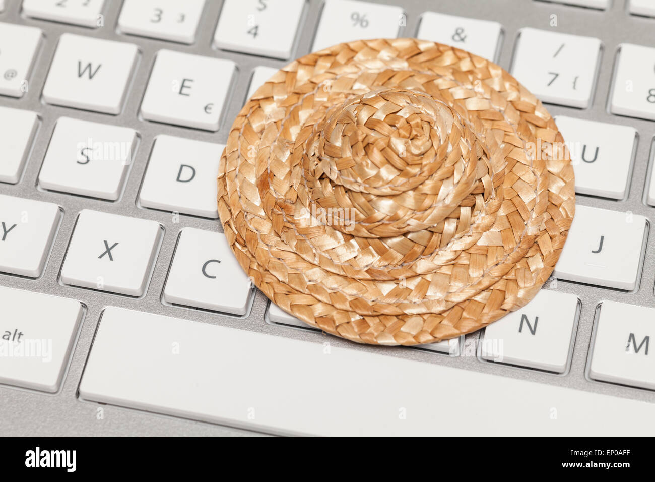 Straw hat on keyboard Stock Photo - Alamy