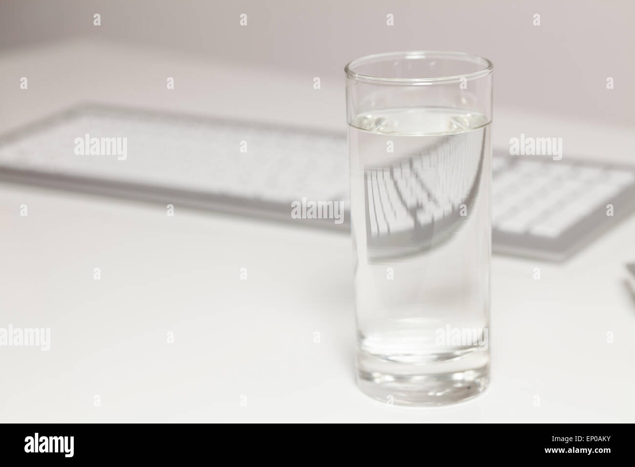 Glass of water on desk Stock Photo - Alamy