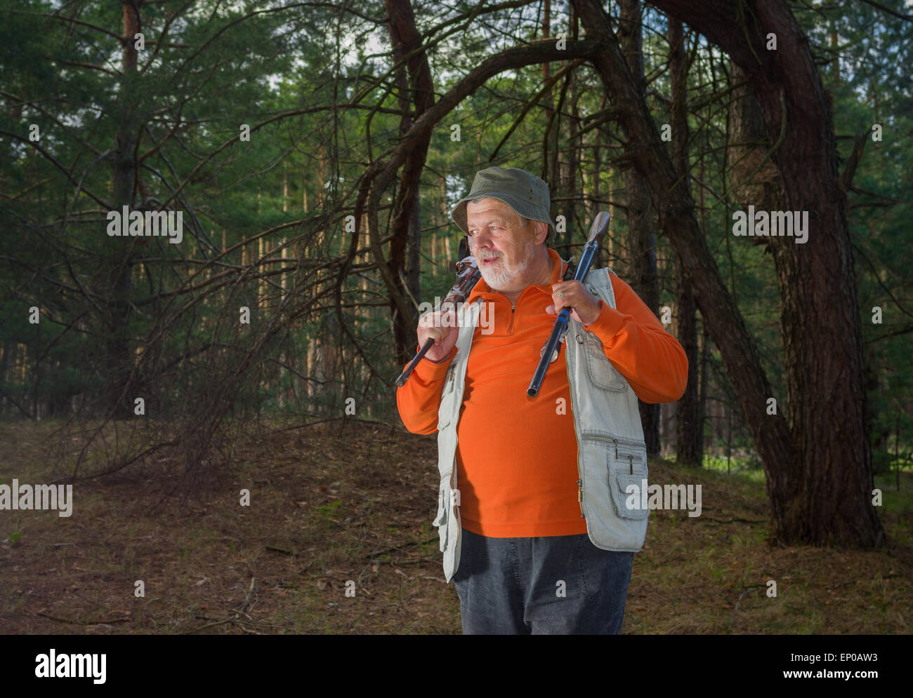 Outdoor portrait of senior ranger with two rifles Stock Photo - Alamy